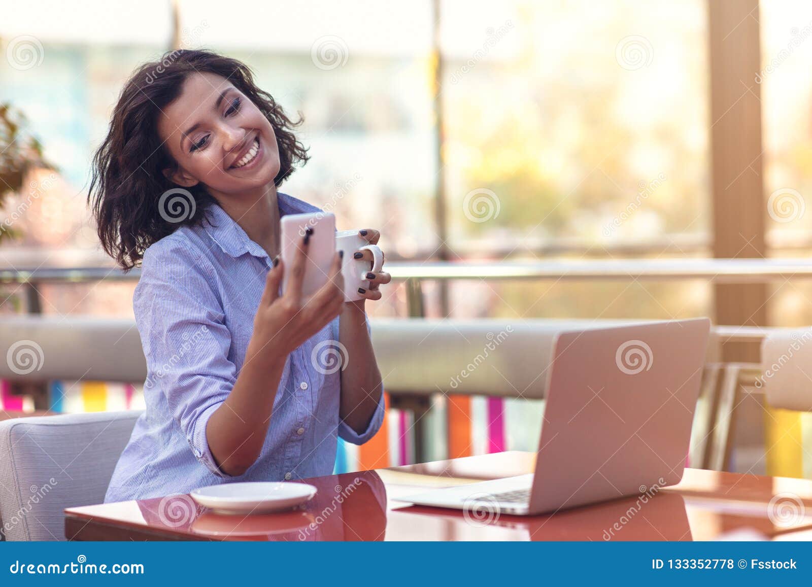 Businesswoman Using Phone while Working in Coffee Shop Stock Photo ... Businesswoman Using Phone while Working in Coffee Shop Stock Photo ...