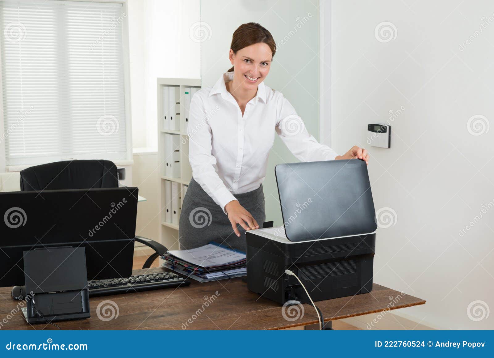 Businesswoman Using Printer in Office Stock Photo - Image of ...