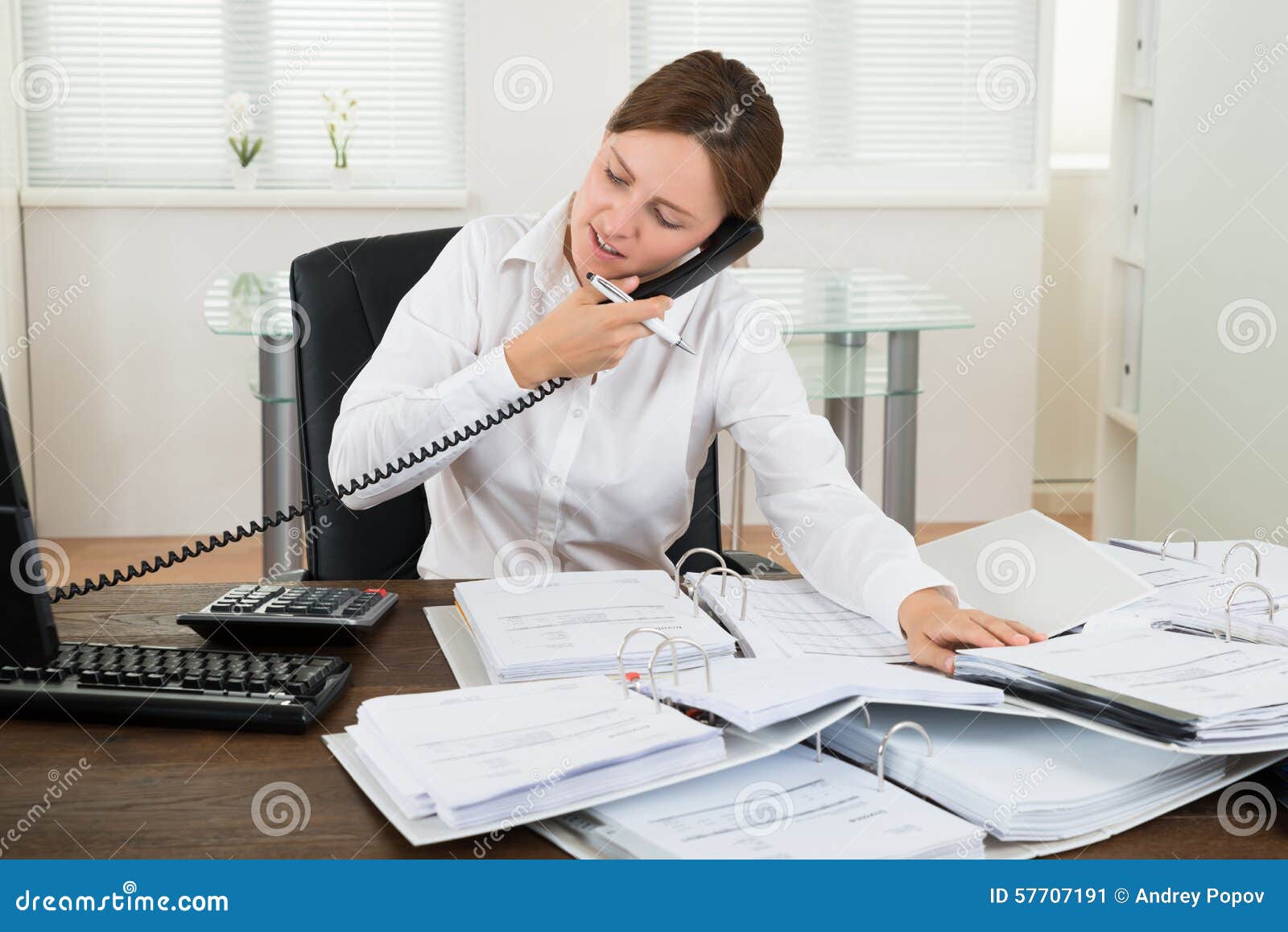 Businesswoman Using Telephone while Doing Accounting Stock Image ...