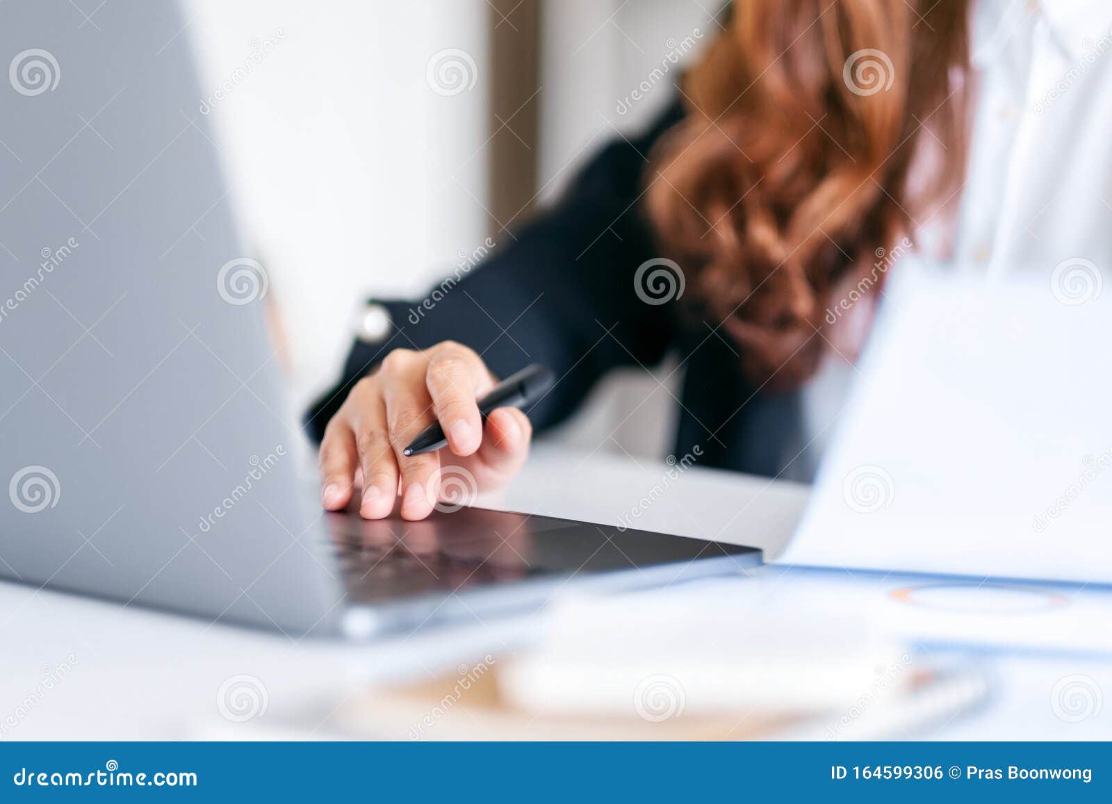 Businesswoman Using and Working on Laptop Computer and Paperwork Stock ...