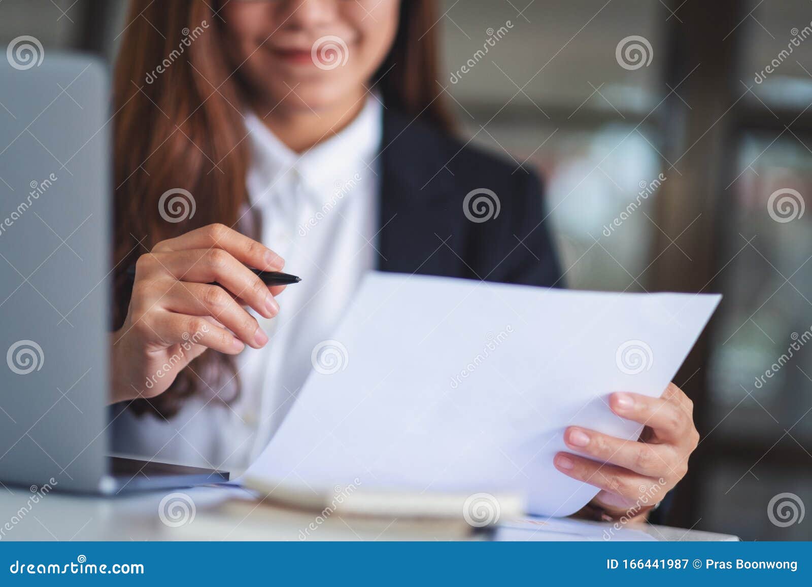Businesswoman Using and Working on Laptop Computer and Paperwork Stock ...