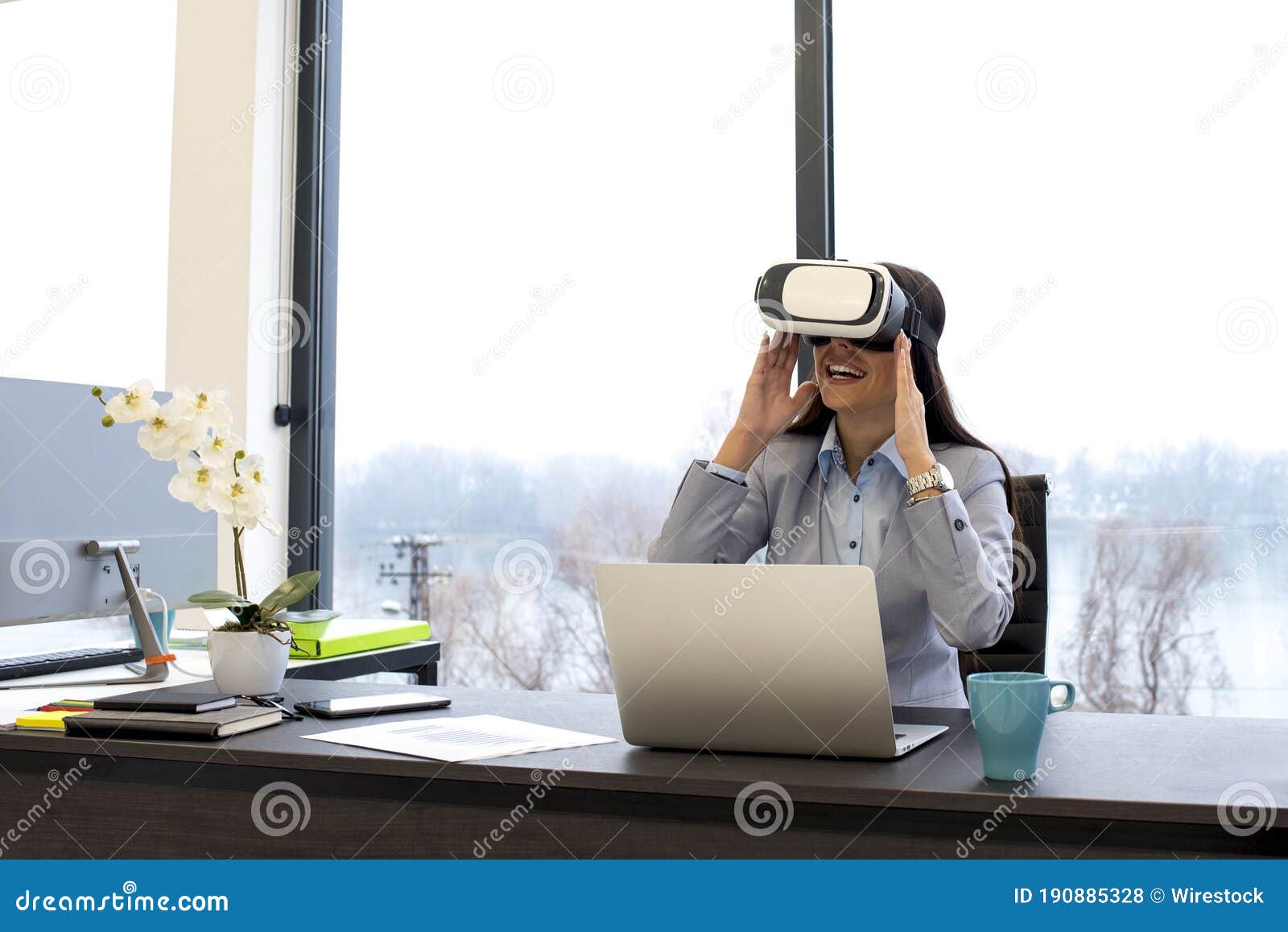 Businesswoman in a VR Headset Enjoying Virtual Project Presentation at ...