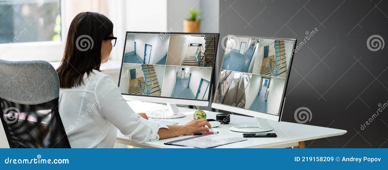 Businesswoman Watching CCTV Footage of Office Interior Stock Image ...