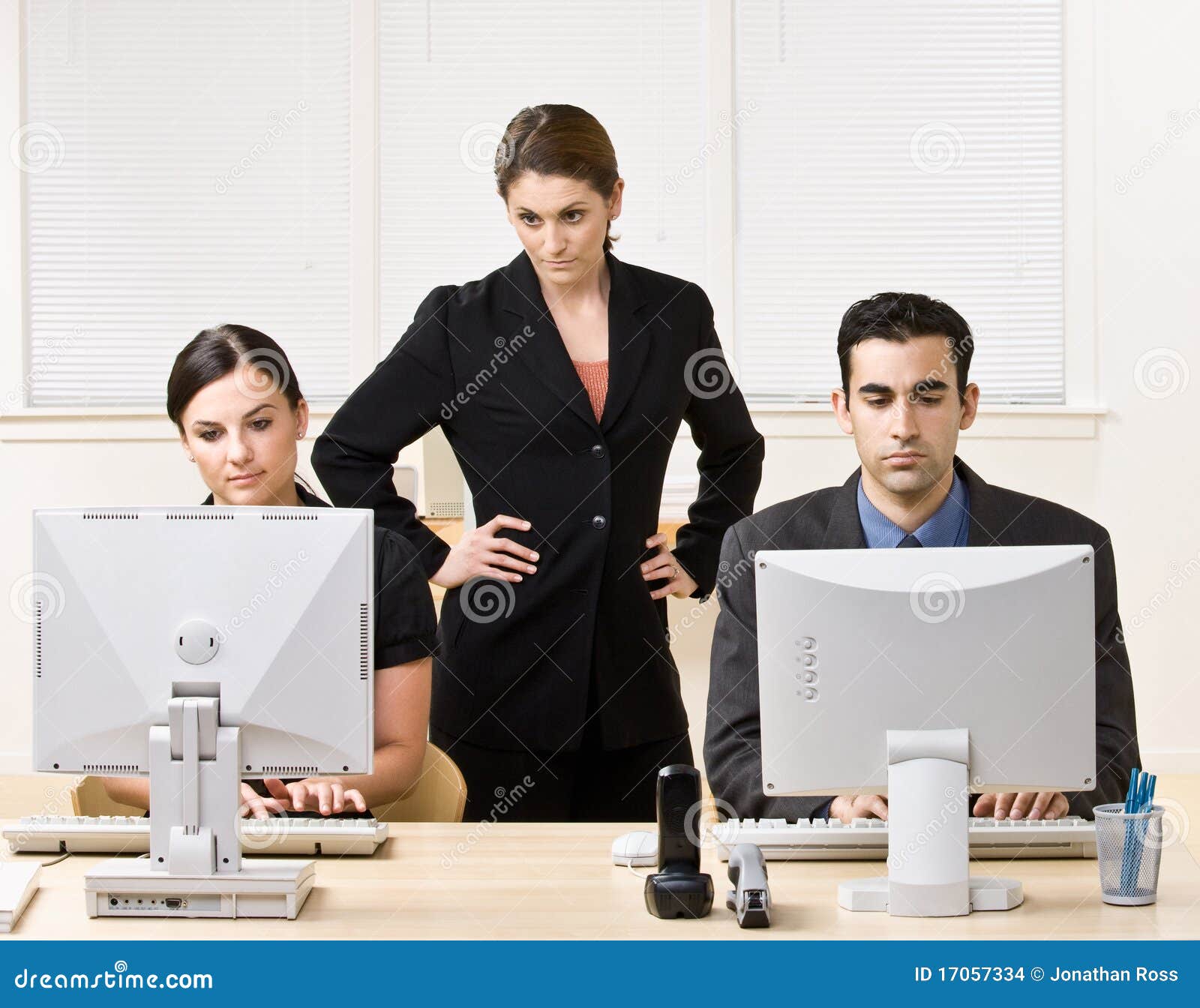 Businesswoman Watching Co-workers Work Stock Photo - Image of person ...