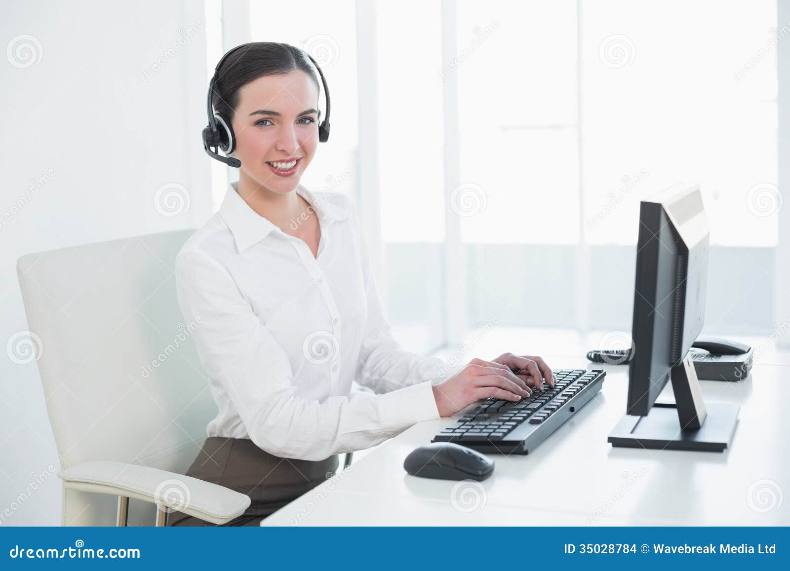 Businesswoman Wearing Headset while Using Computer Stock Photo - Image ...