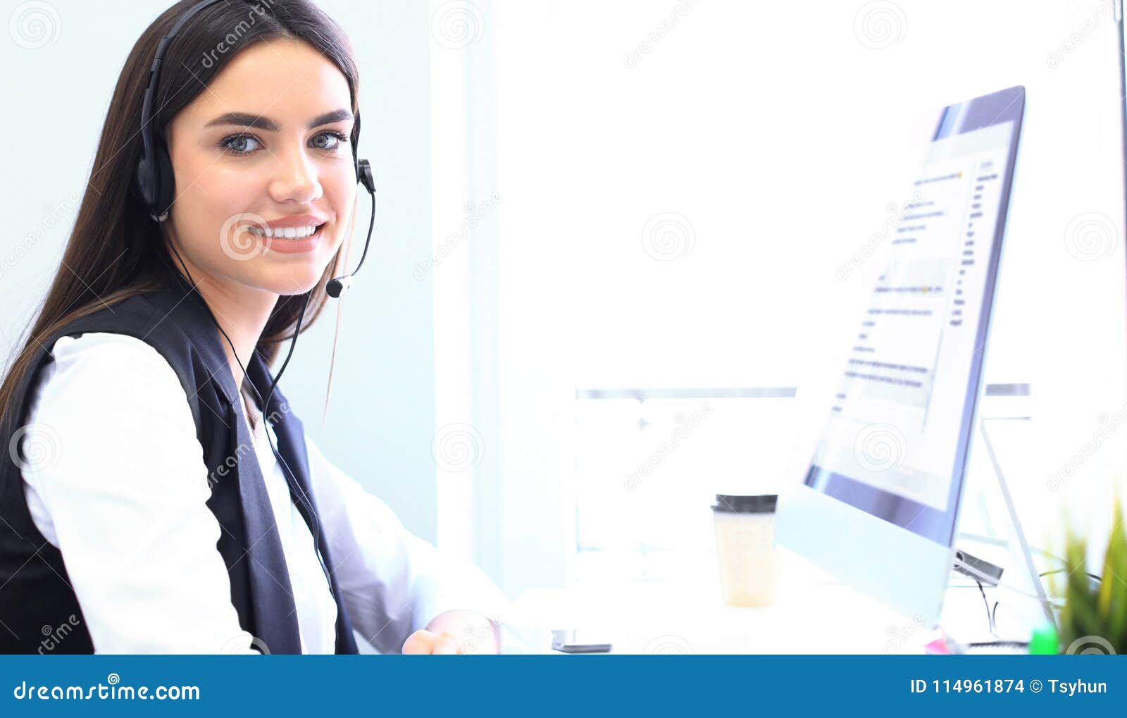 Businesswoman Wearing Microphone Headset Using Computer in the Office ...