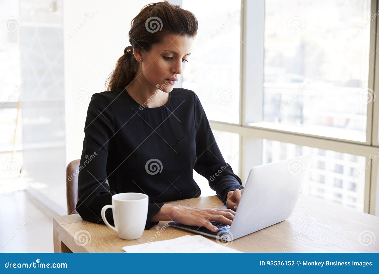 Businesswoman Working Alone on Laptop in Office Boardroom Stock Photo ...