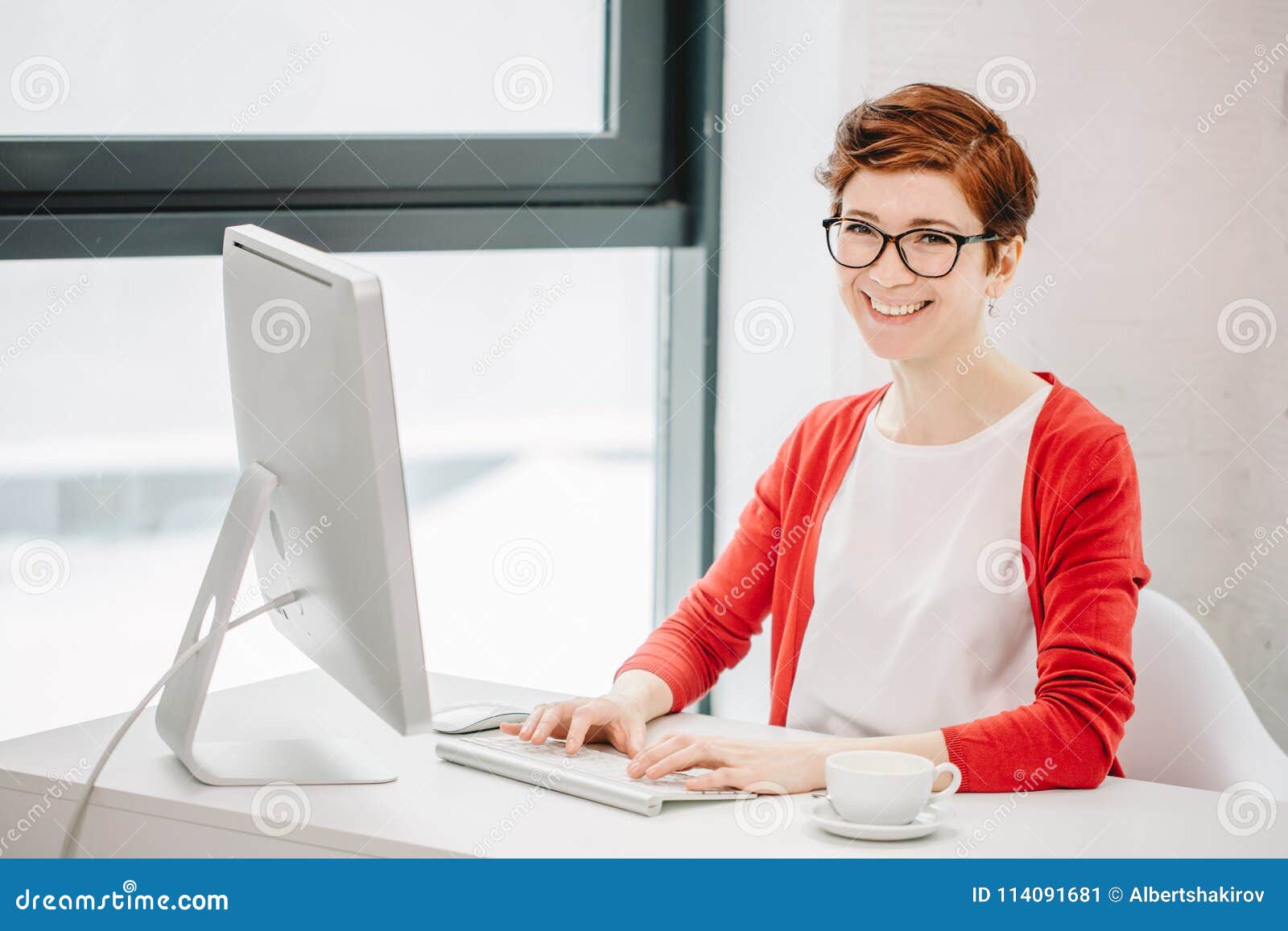 Businesswoman Working on Computer and Looking at Camera in Office Stock ...