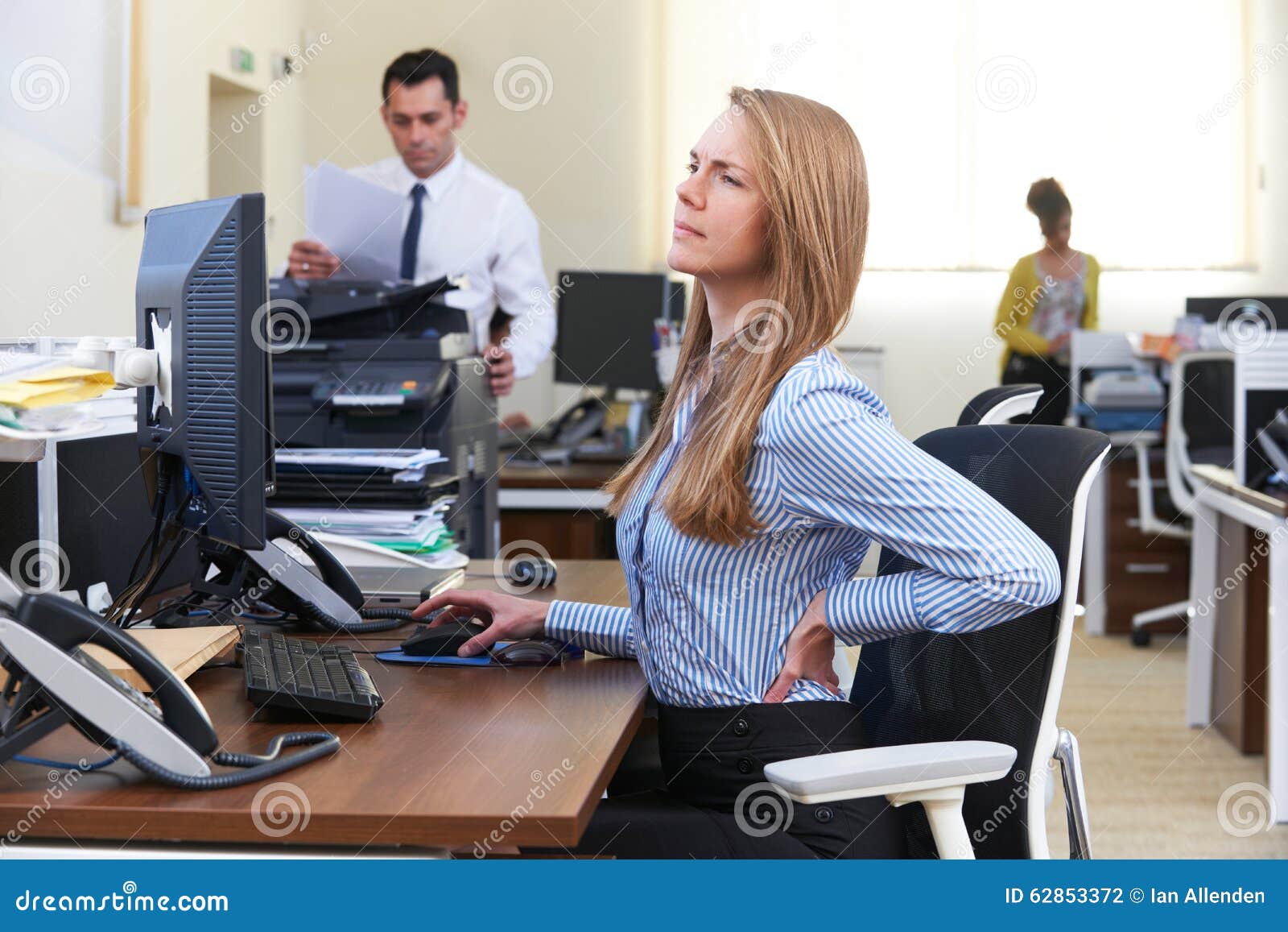 Businesswoman Working at Desk Suffering from Backache Stock Photo ...