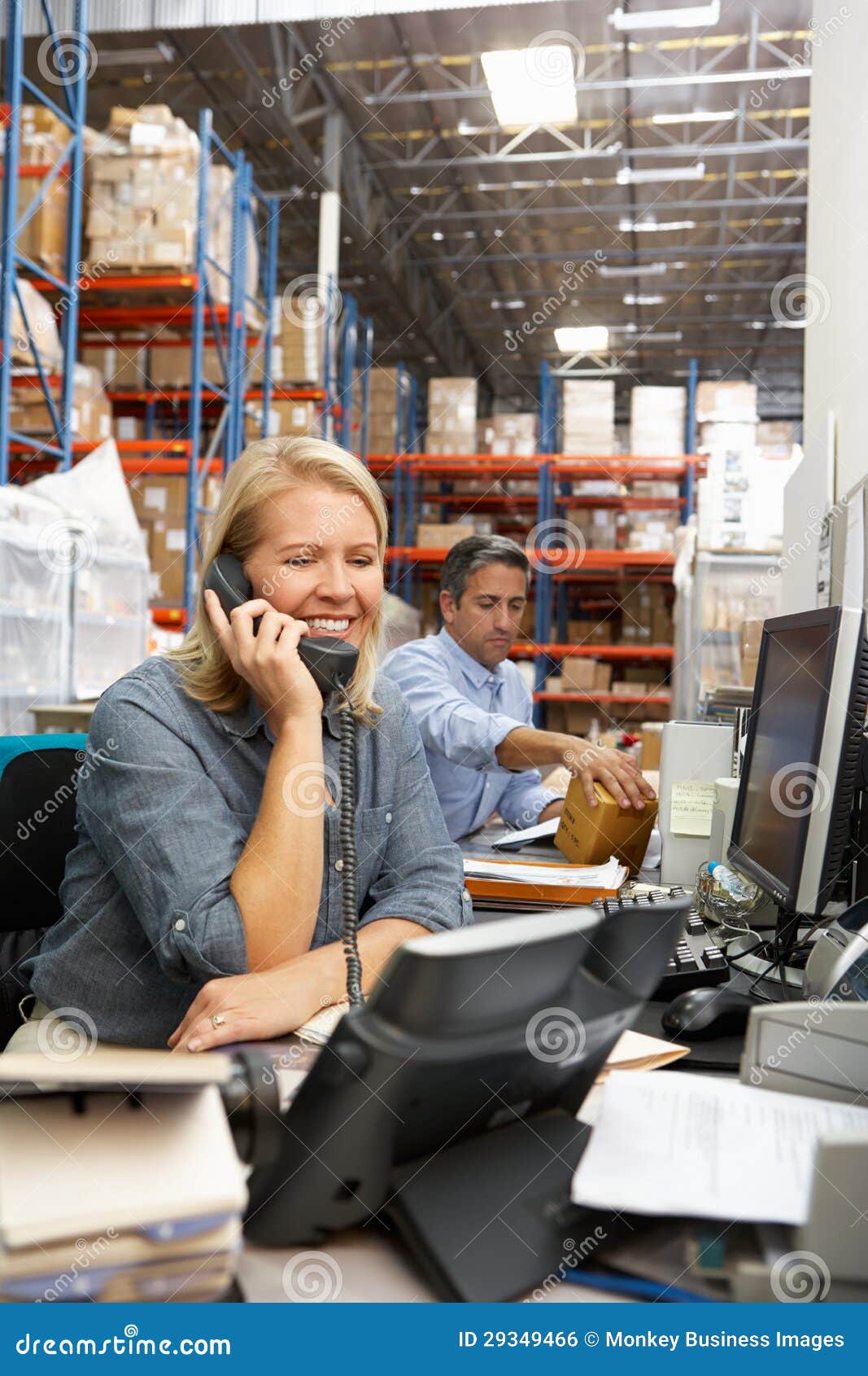 Businesswoman Working at Desk in Warehouse Stock Photo - Image of ...