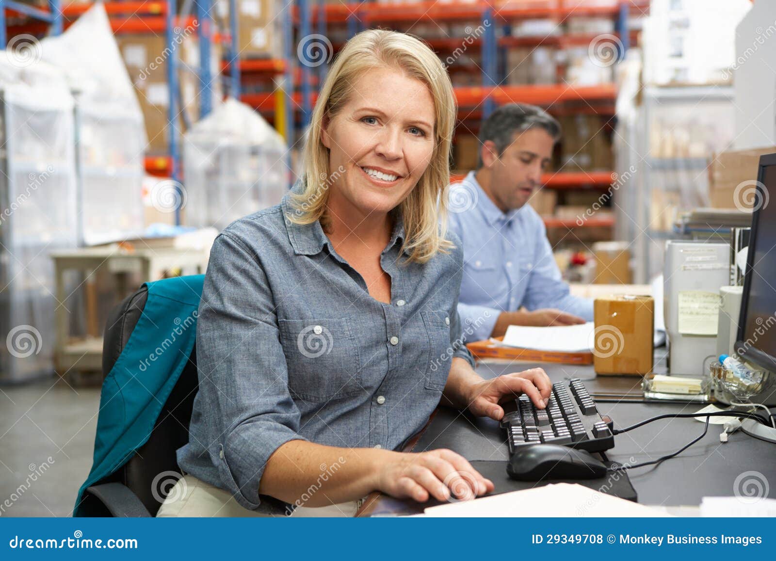Businesswoman Working at Desk in Warehouse Stock Photo - Image of ...