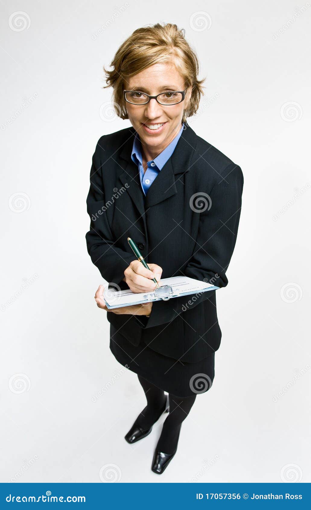 Businesswoman Writing on Clipboard Stock Photo - Image of clothes ...