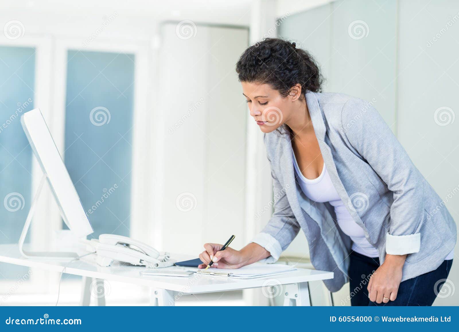 Businesswoman Writing on Document at Desk Stock Photo - Image of female ...