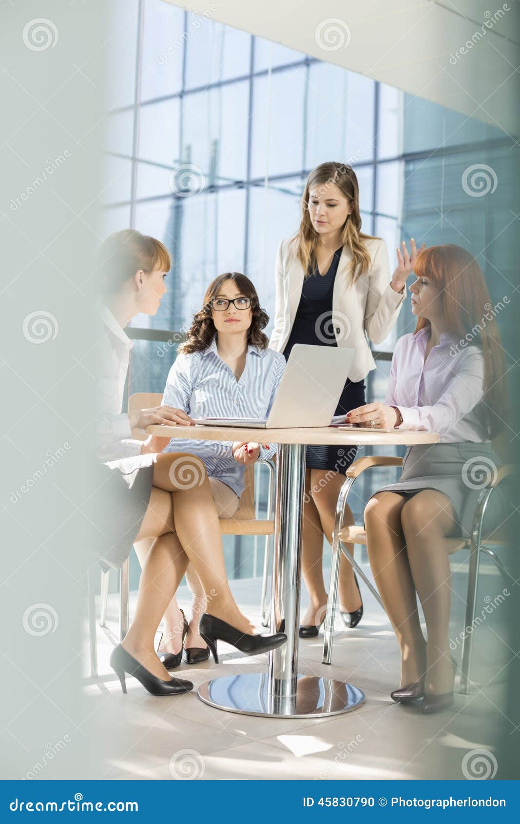 Businesswomen Discussing at Table in Office Stock Photo - Image of ...