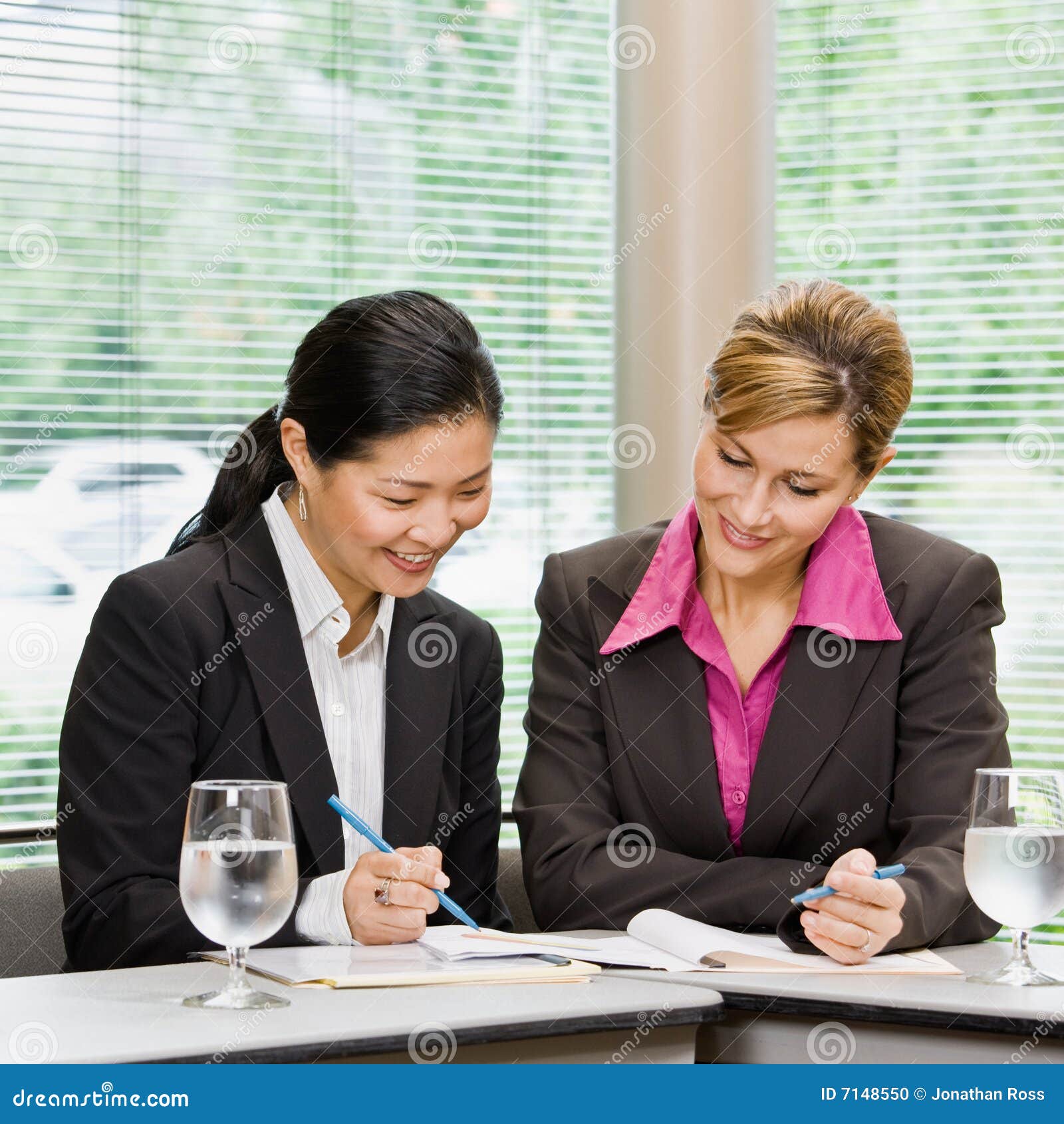 Businesswomen Reviewing Paperwork Stock Photo - Image of partner ...
