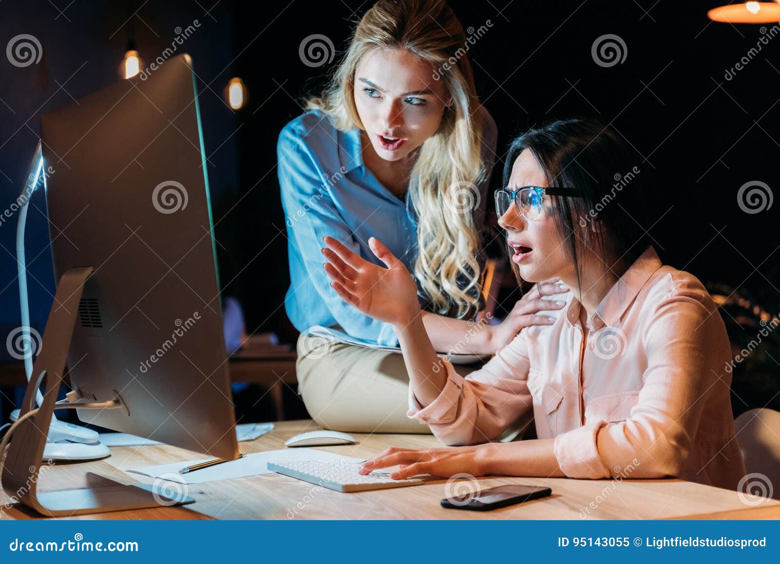 Businesswomen Working On Computer While Discussing New Project Together