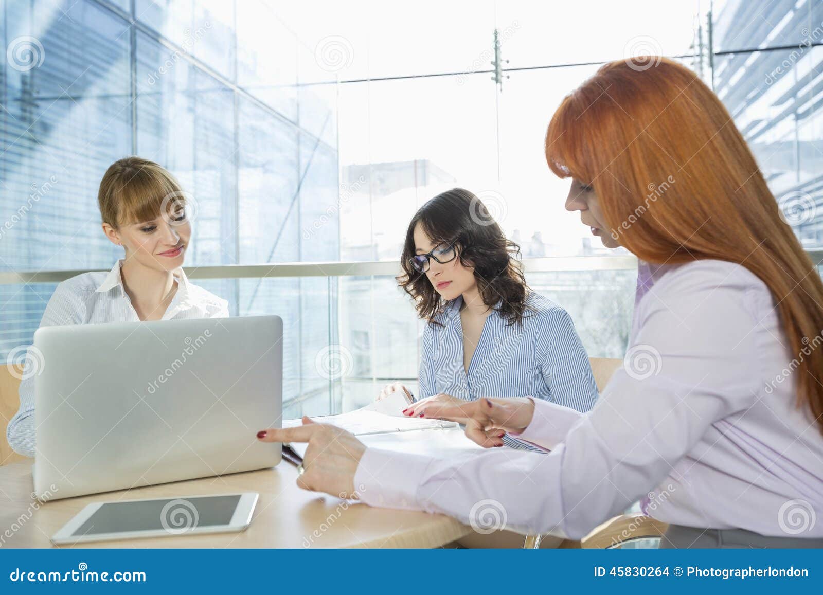 Businesswomen Working at Table in Office Stock Photo - Image of glass ...