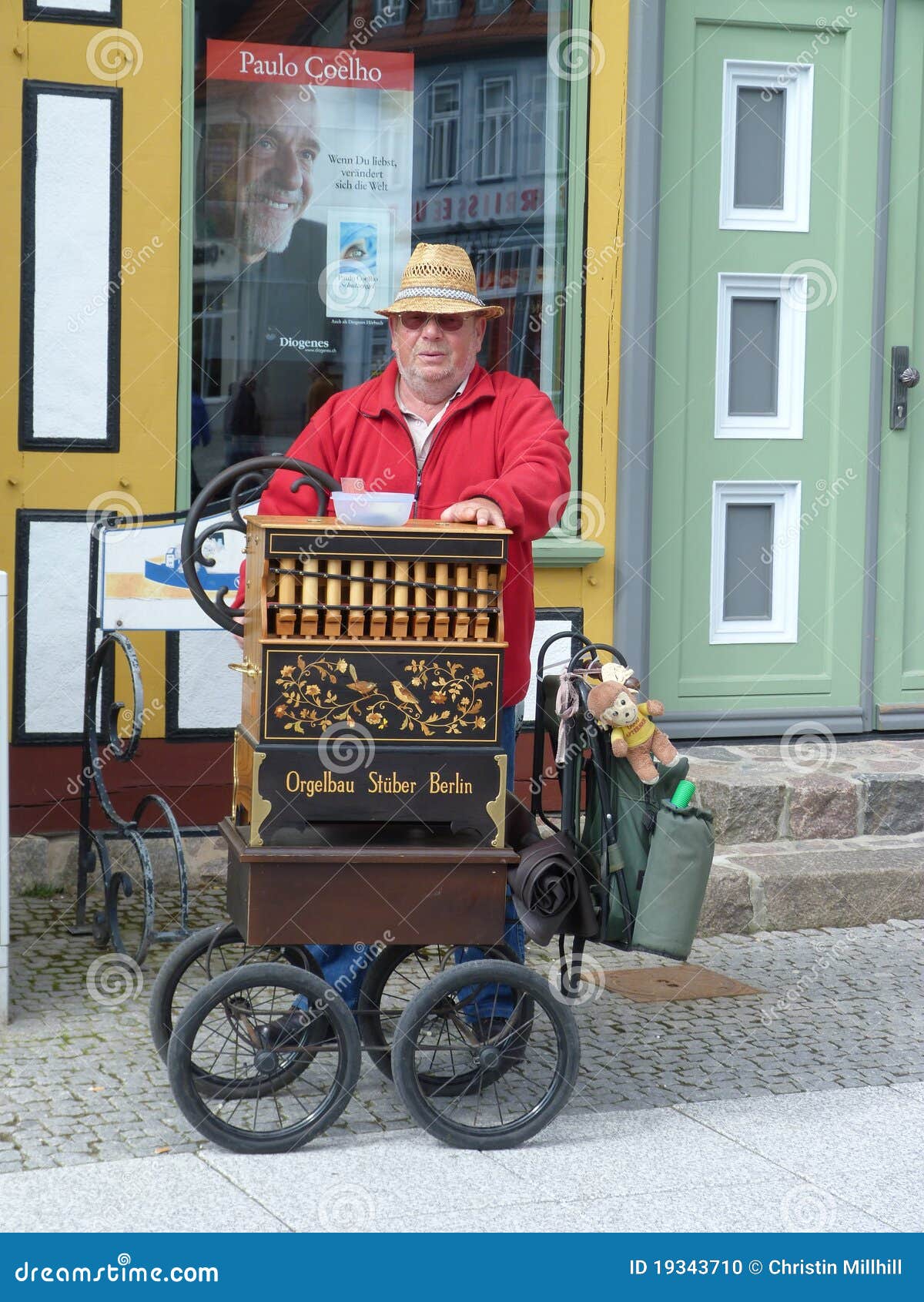 An Old Man Busker Playing The Bayan On The Promenade, People Walking On ...