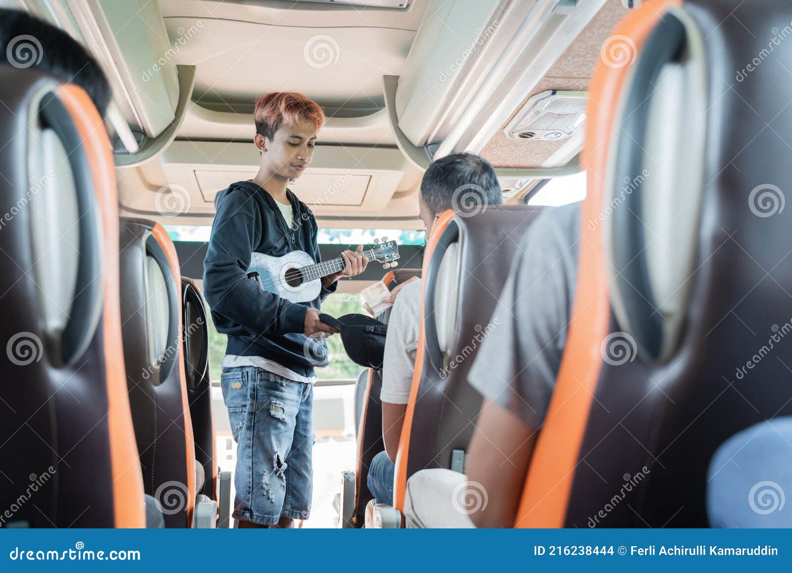 A Busker Using an Ukulele Instrument and a Hat Asking Bus Passengers ...