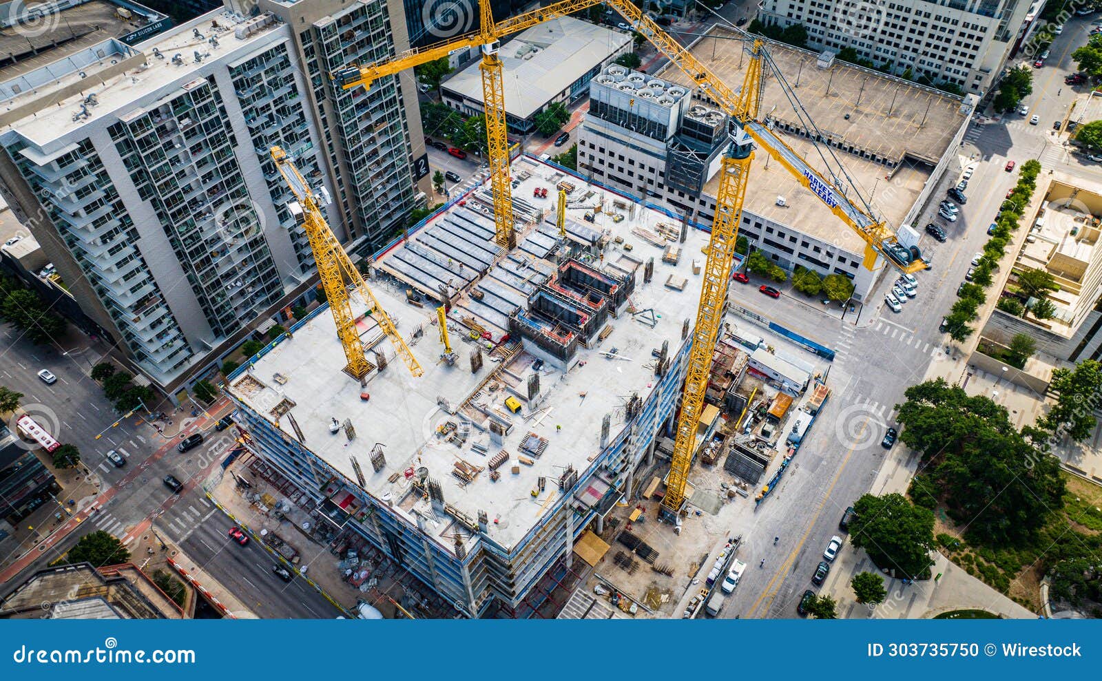 Bustling Construction Site With Cranes And Scaffolding Around A Multi ...