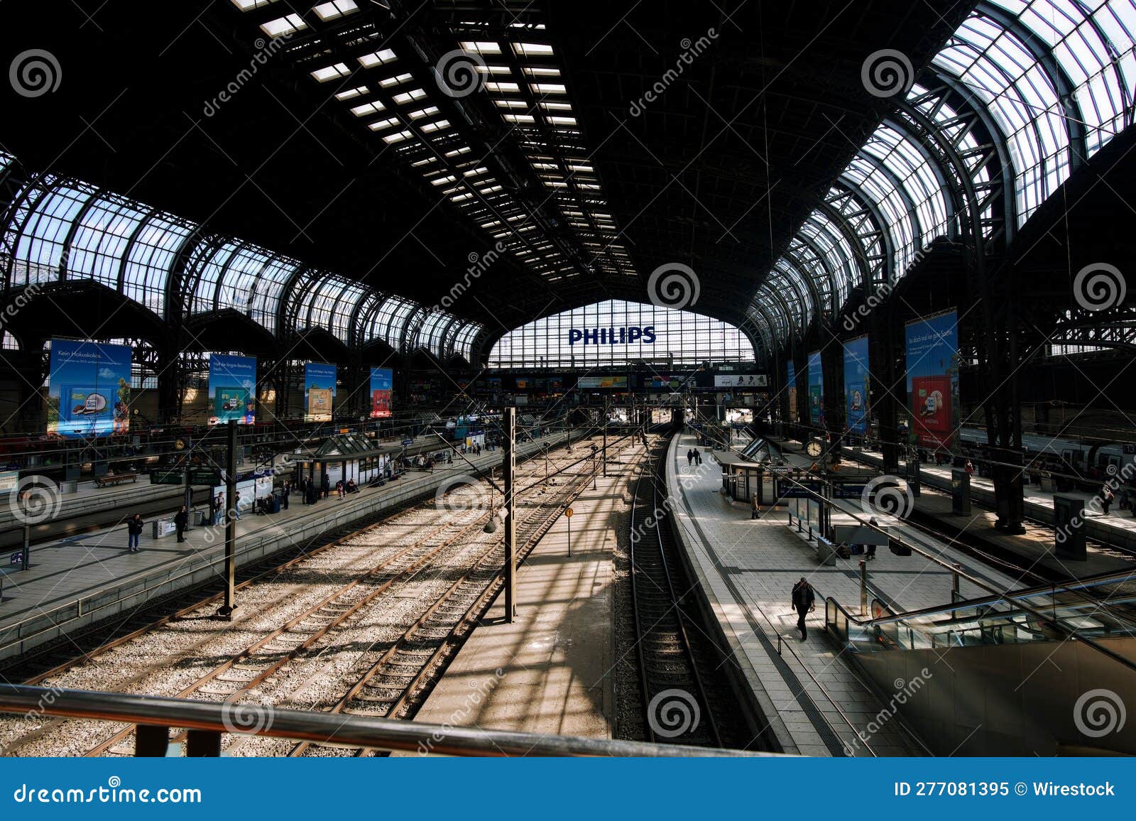A Group of Train Platforms and Some People Walking Around it Editorial ...