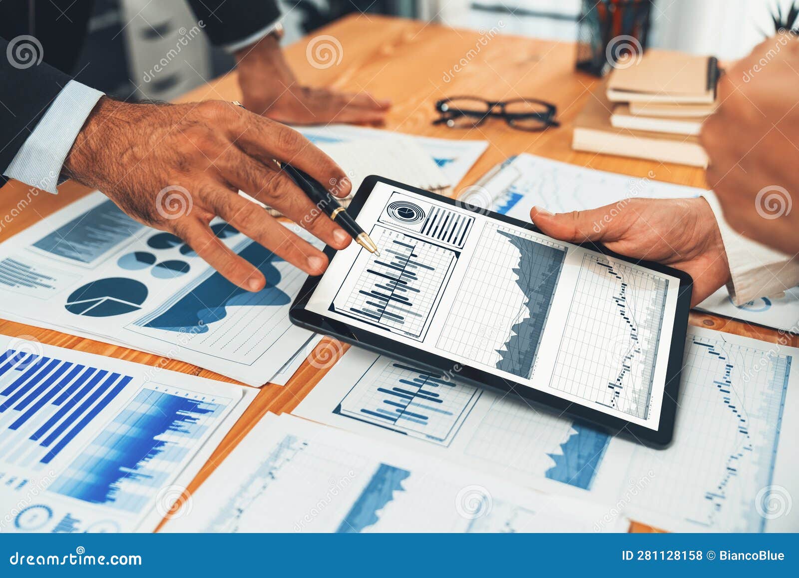 Busy Analyst Team Discussing Financial Data on Tablet. Fervent Stock ...