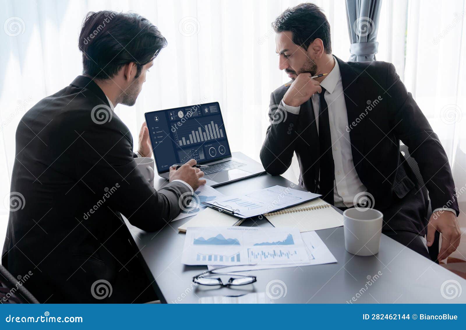 Busy Analyst Team Discussing Financial Data on Laptop. Fervent Stock ...