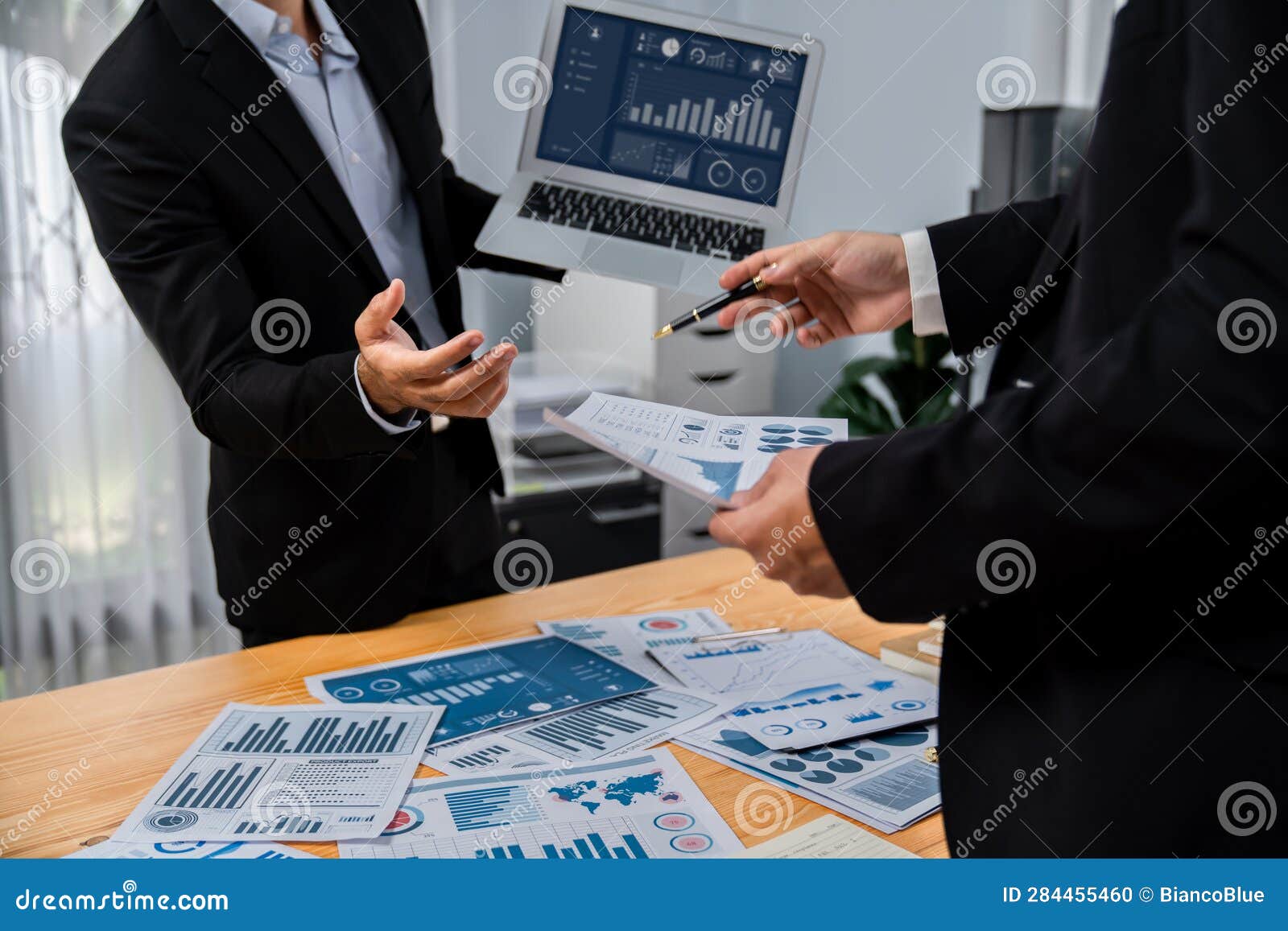 Busy Analyst Team Discussing Financial Data on Laptop. Fervent Stock ...