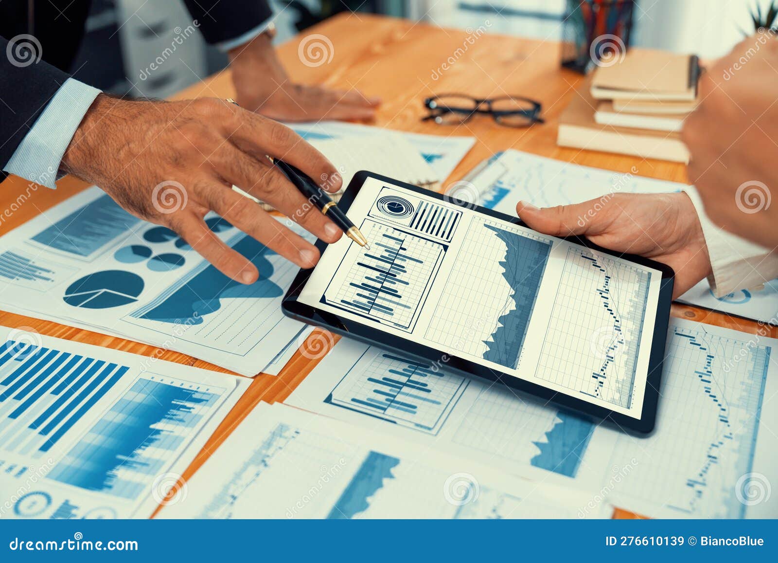 Busy Analyst Team Discussing Financial Data on Tablet. Fervent Stock ...