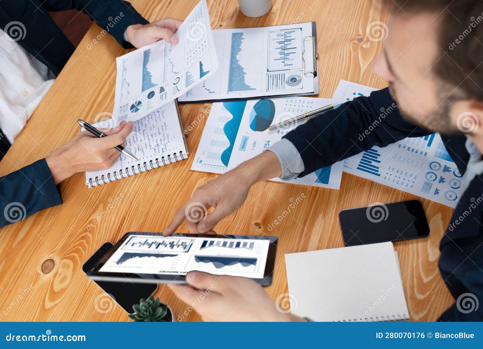 Busy Analyst Team in Office Analyzing Financial Data Analysis by Tablet ...