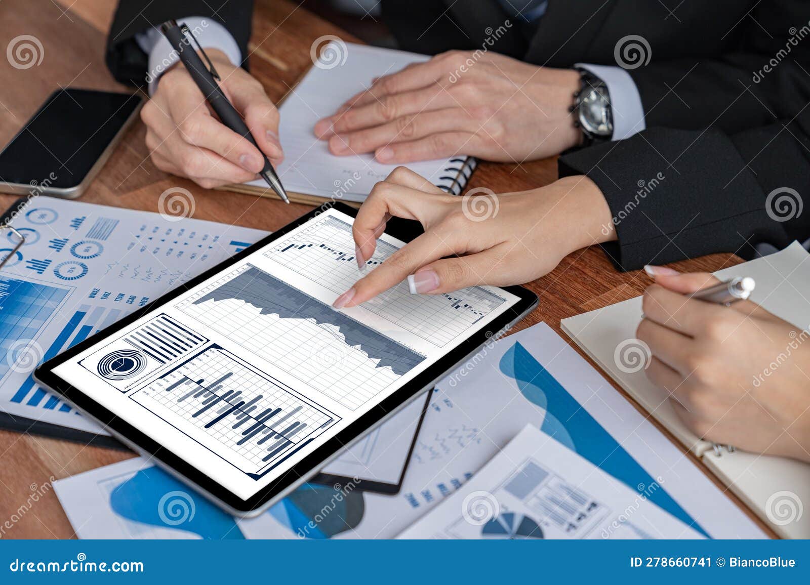 Busy Analyst Team in Office Discuss Data Analysis on Tablet Screen ...