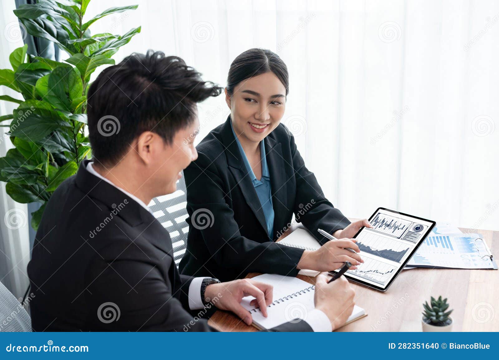 Busy Analyst Team in Office Discuss Data Analysis on Tablet Screen ...