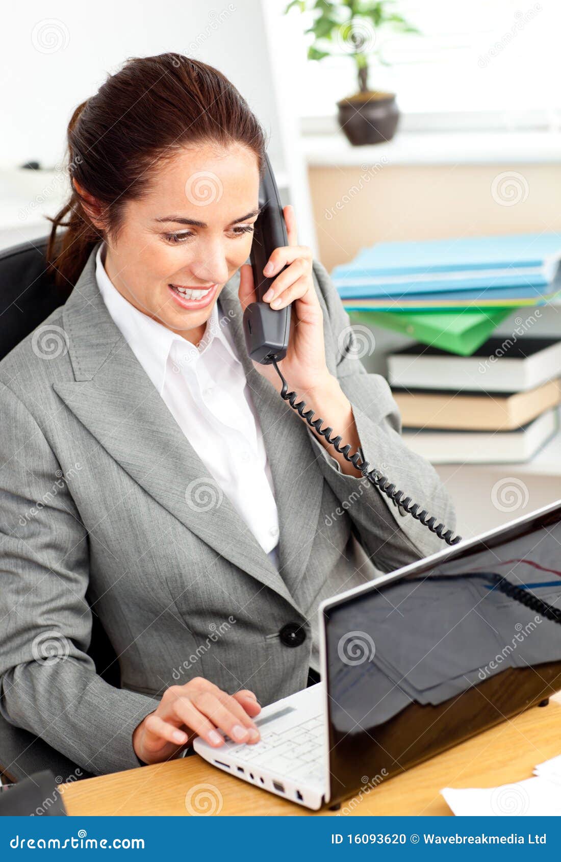 Busy Businesswoman Phoning and Using Her Laptop Stock Photo - Image of ...
