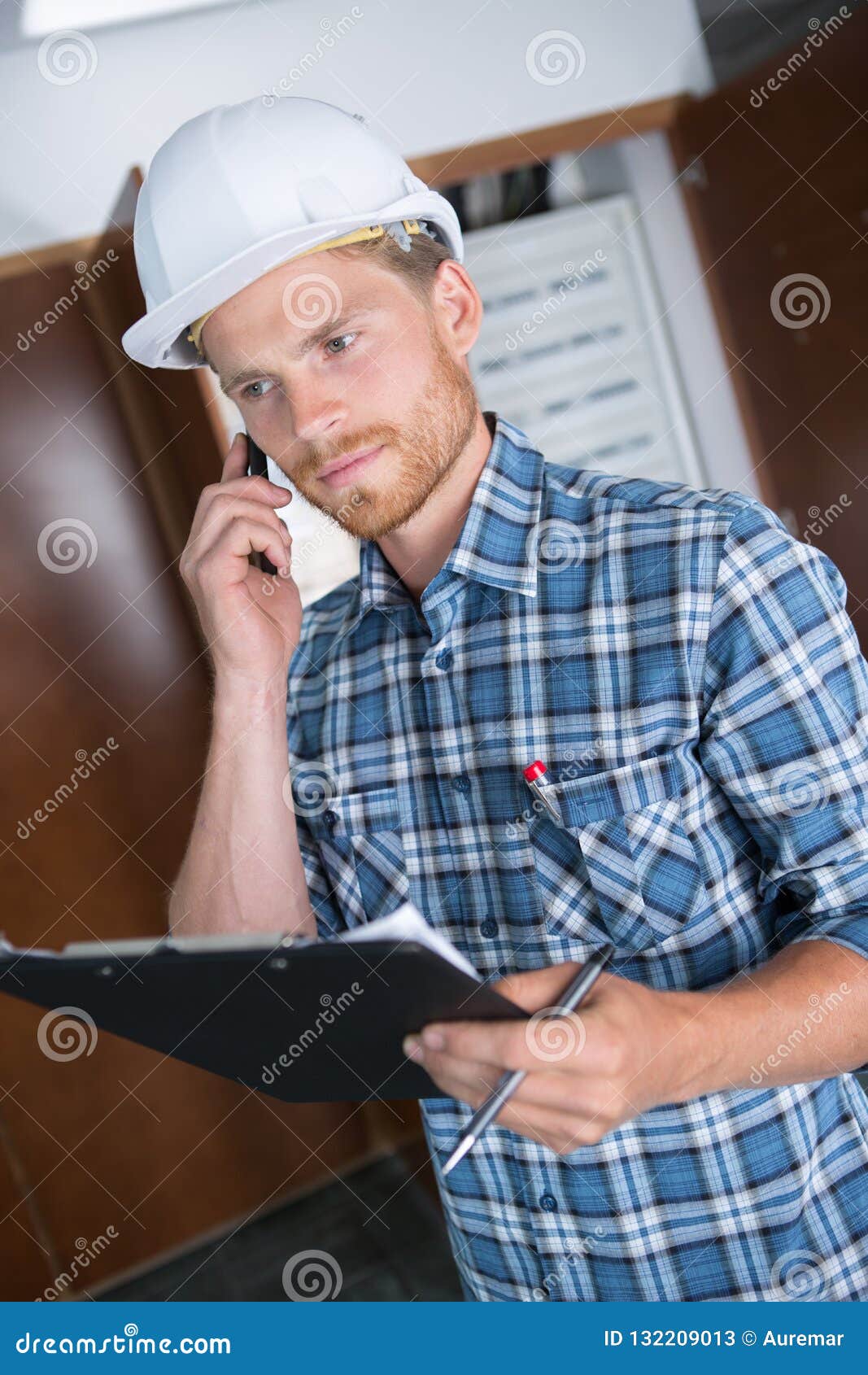Busy Construction Engineer Talking on Phone and Holding Clipboard Stock ...