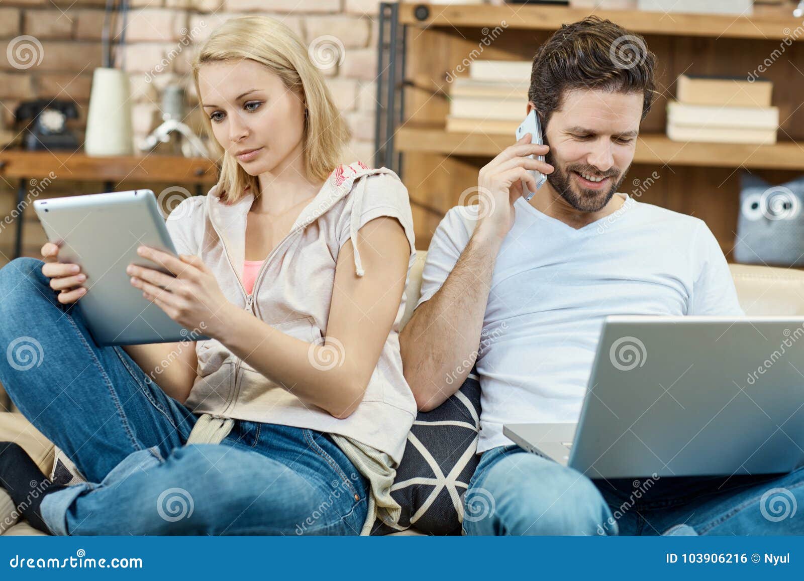 Busy couple at home stock photo. Image of cellular, girlfriend - 103906216