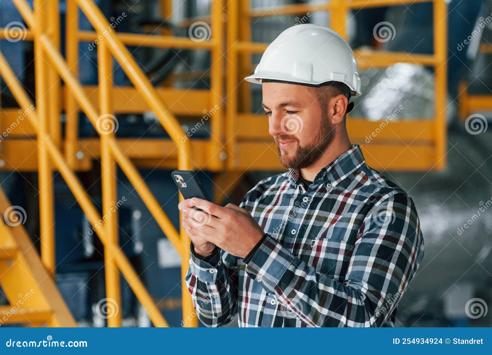 Busy Day. Construction Worker in Uniform is in the Factory Stock Photo ...