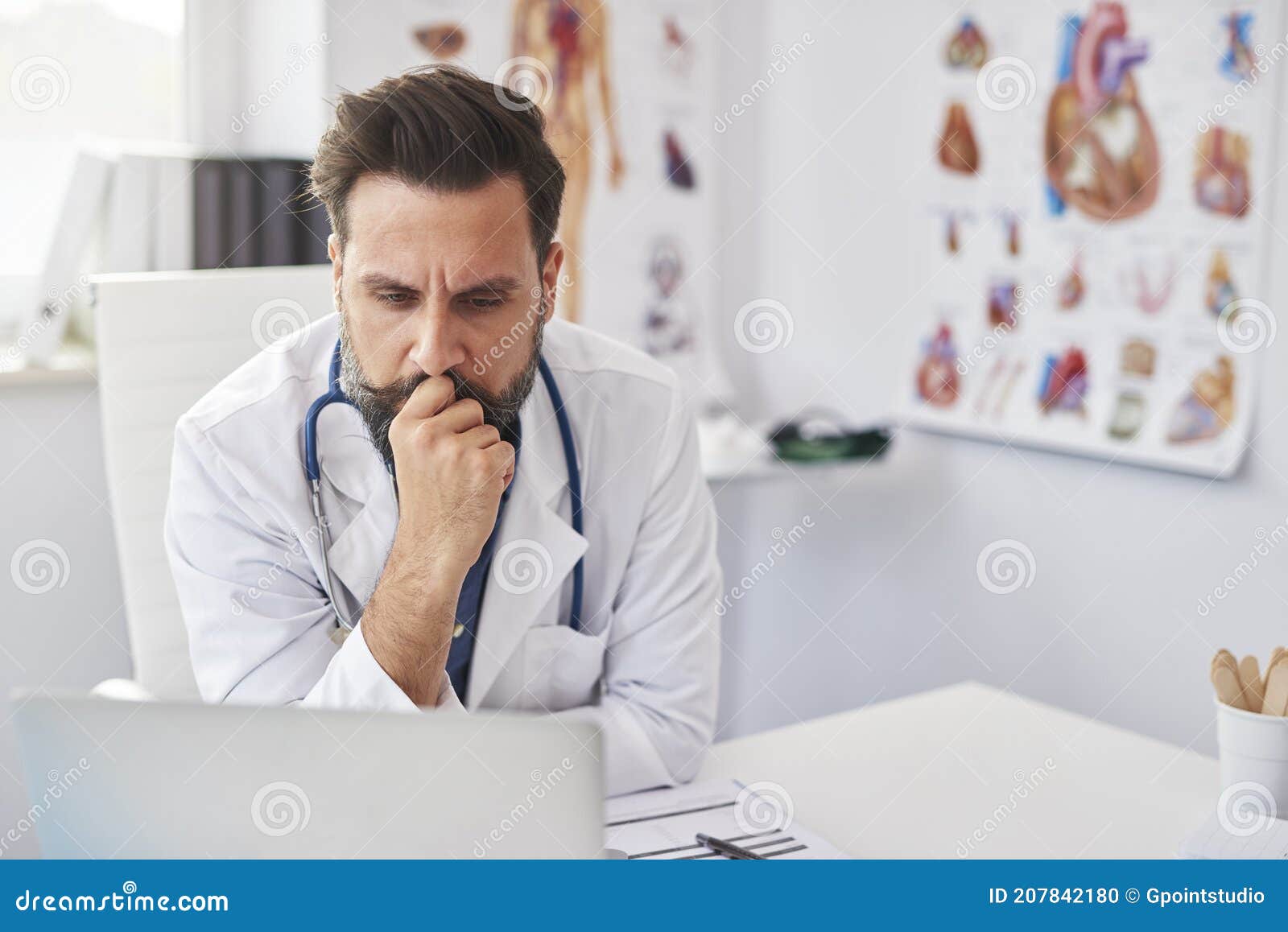 Busy Doctor Working with Laptop in Doctorâ€™s Office Stock Photo ...