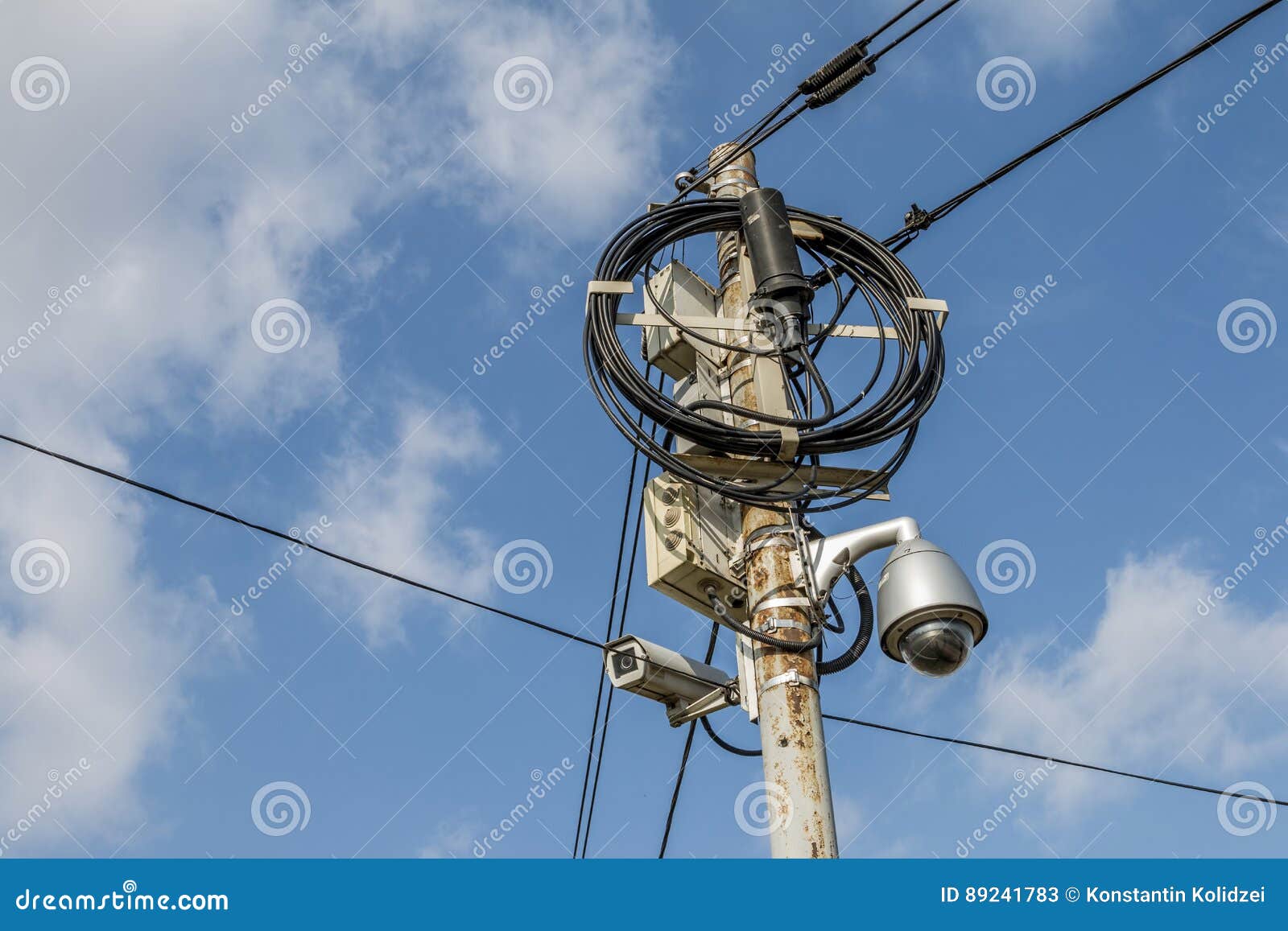 Busy Electricity Line and Security Camera Against Blue Sky. Stock Image ...