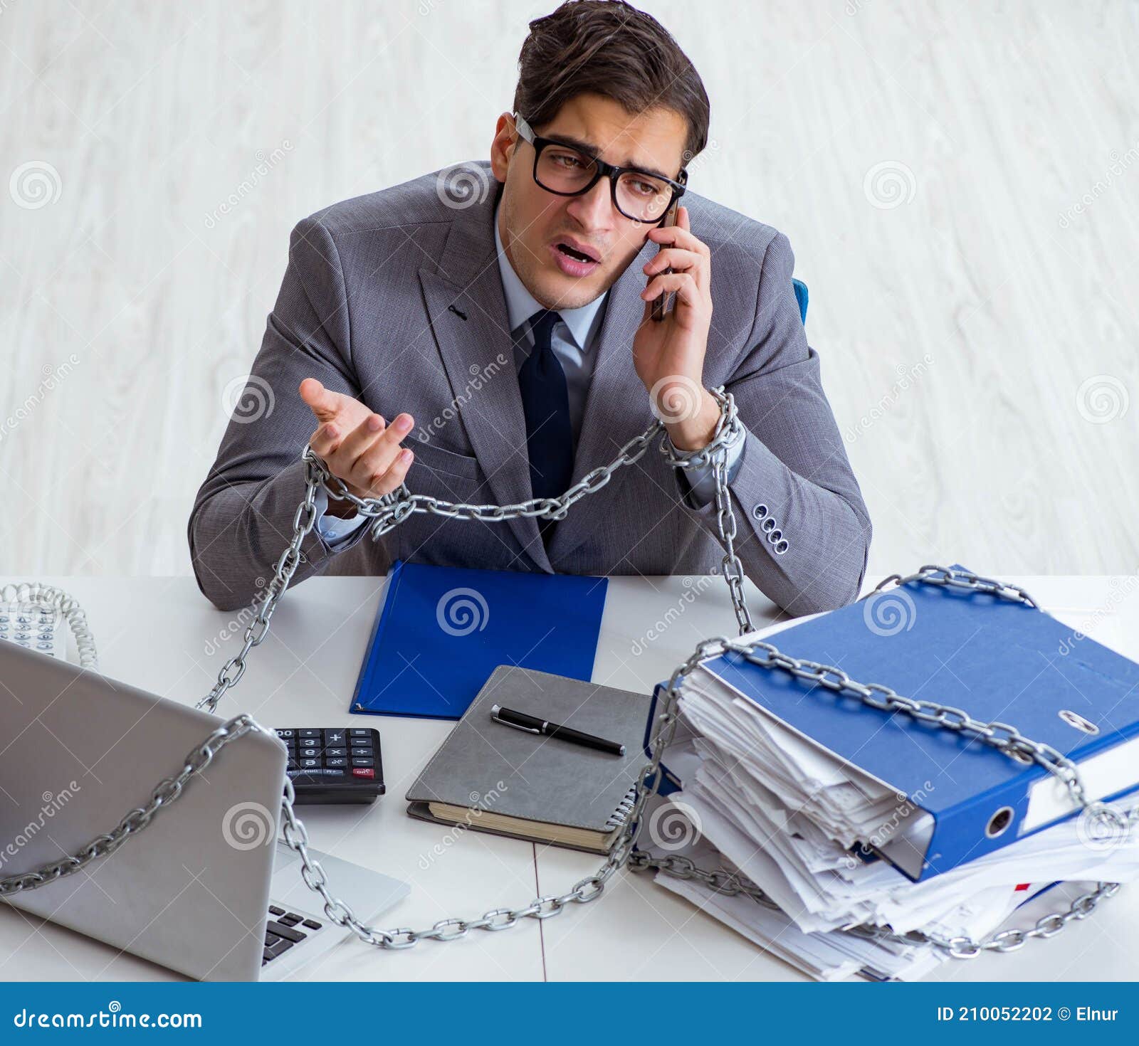Busy Employee Chained To His Office Desk Stock Photo - Image of ...