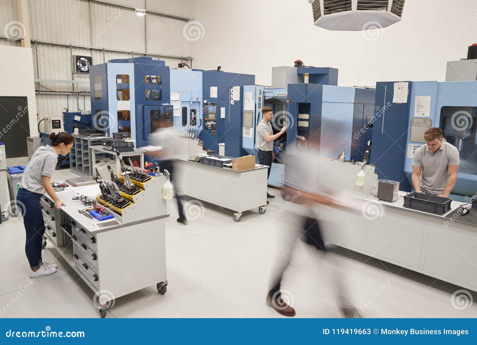 Busy Engineering Workshop with Workers Using CNC Machinery Stock Image ...