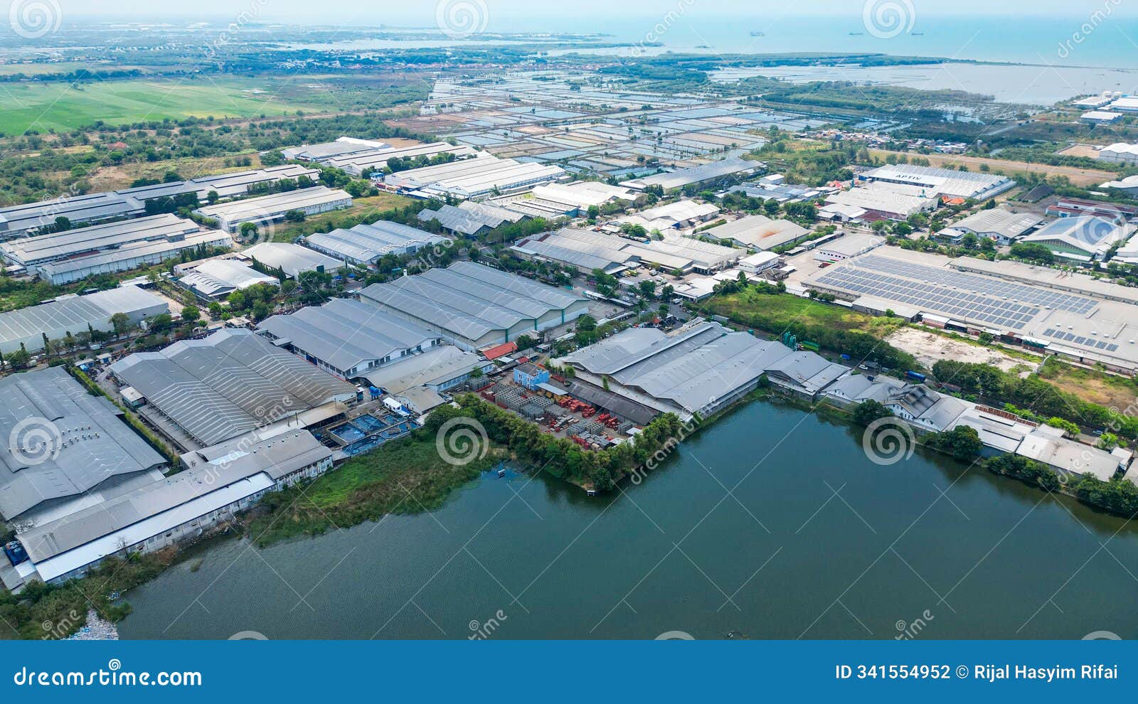 A Busy Factory with Large Tanks and Trucks Loading and Unloading. Stock ...