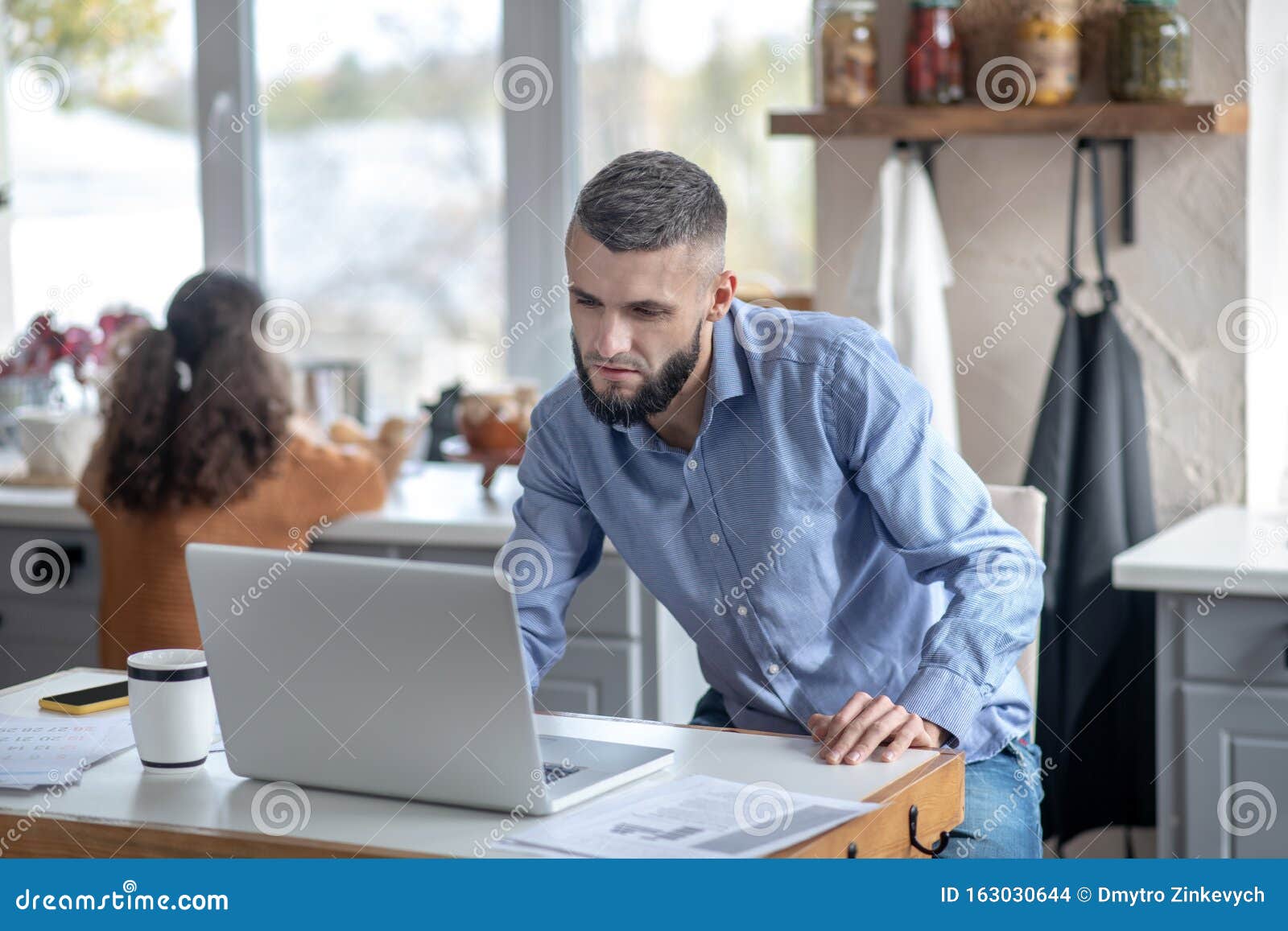 Busy Father Reading E-mail while Sitting in the Kitchen Stock Photo ...