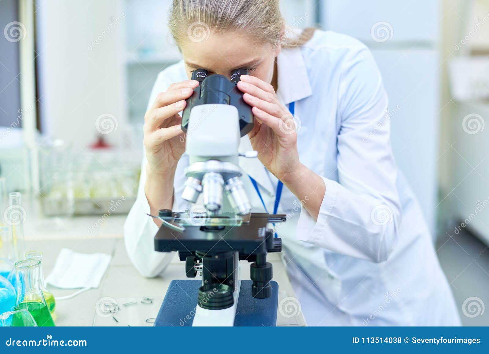 Busy Female Biologist Using Microscope in Lab Stock Photo - Image of ...