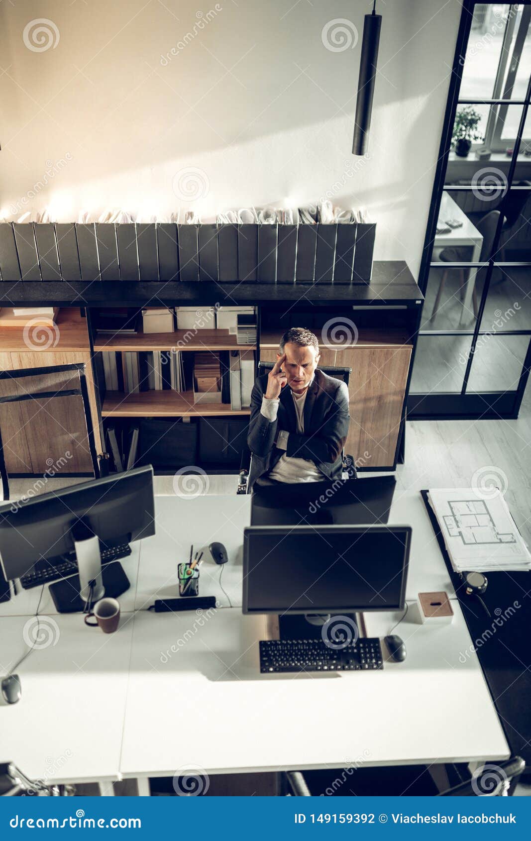 Busy Interior Designer Sitting in Front of Computer Feeling Thoughtful ...