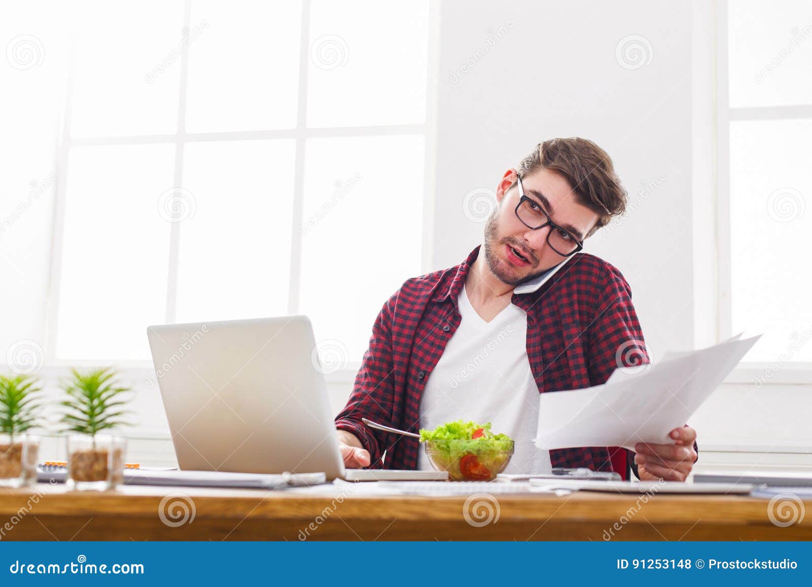 Busy Man Has Business Lunch in Modern Office Interior Stock Photo ...