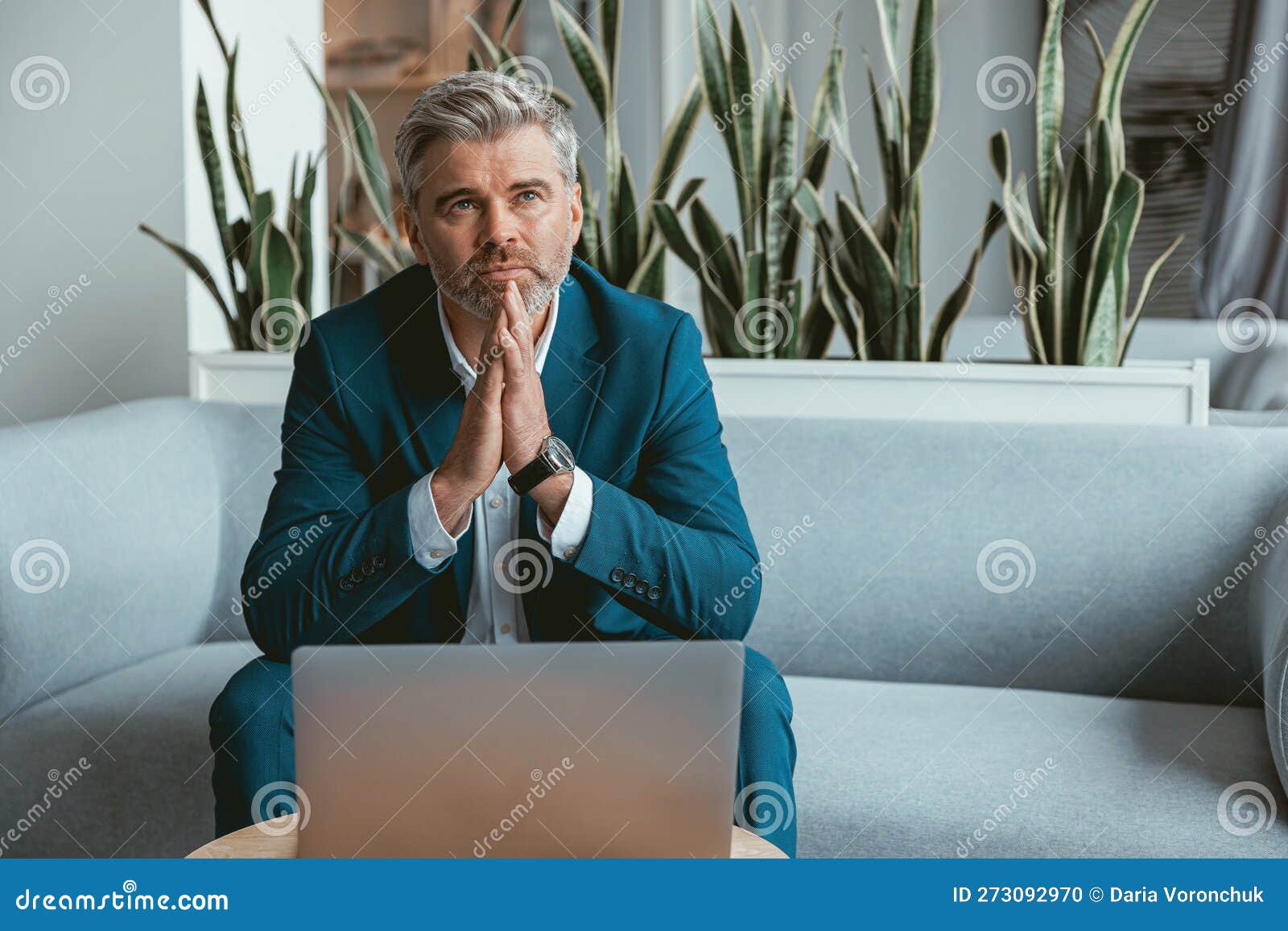 Busy Mature Businessman Workingon Laptop while Sitting in Modern ... Busy Mature Businessman Workingon Laptop while Sitting in Modern ...