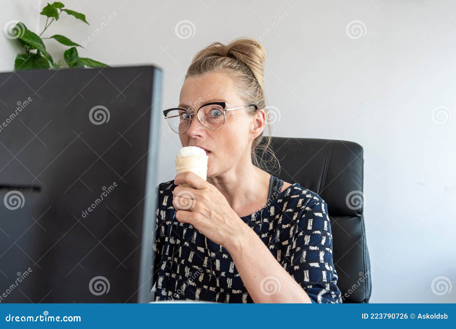 A Busy Office Woman Eats Ice Cream at Her Workplace without ...