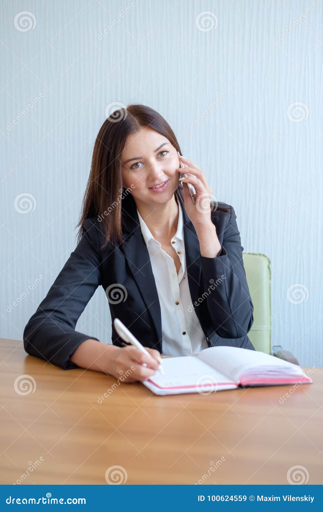 Busy Secretary is Answering Call and Writing Memo at the Same Time ...