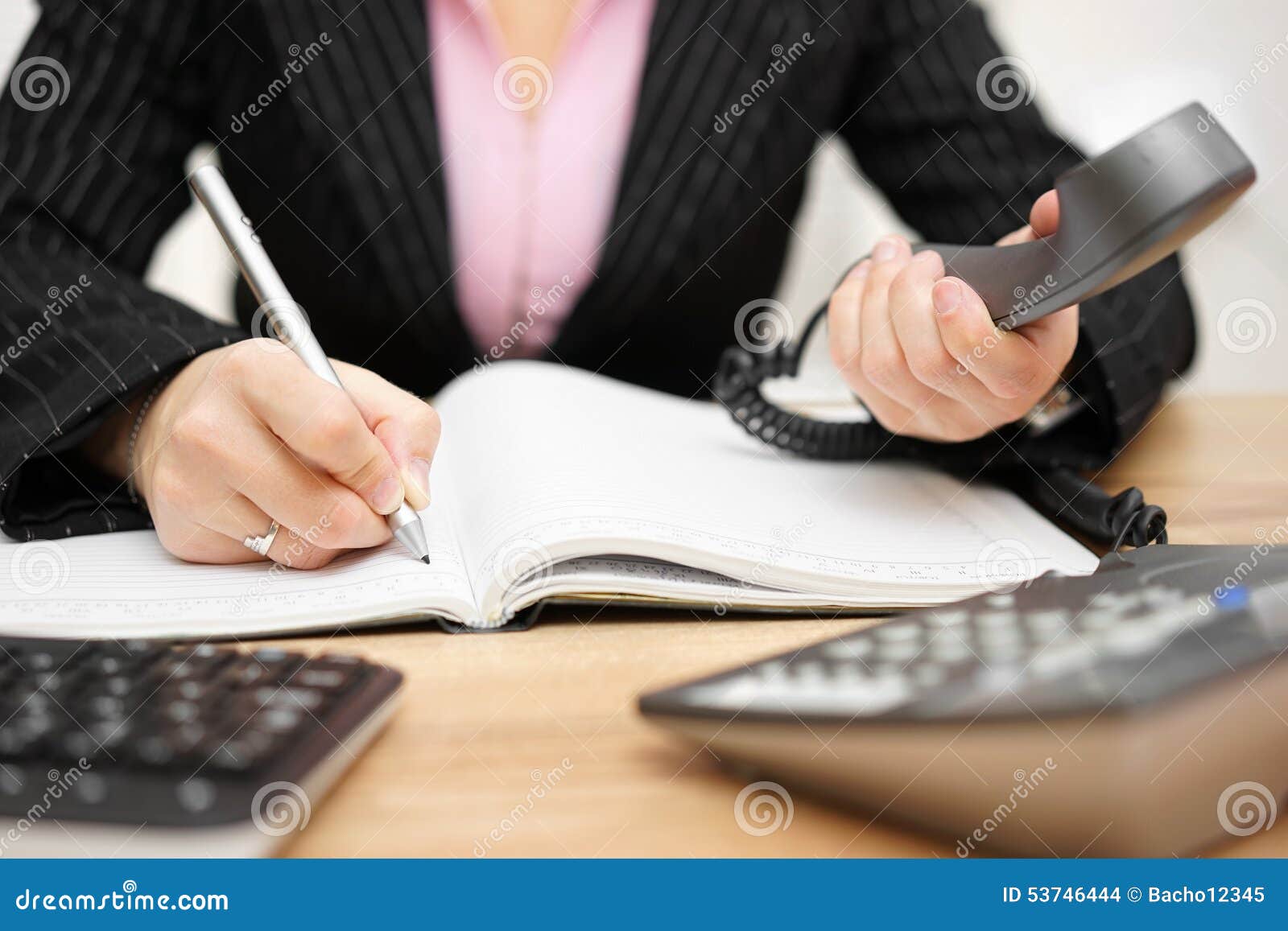Busy Secretary is Answering Call and Writing Memo Stock Photo - Image ...