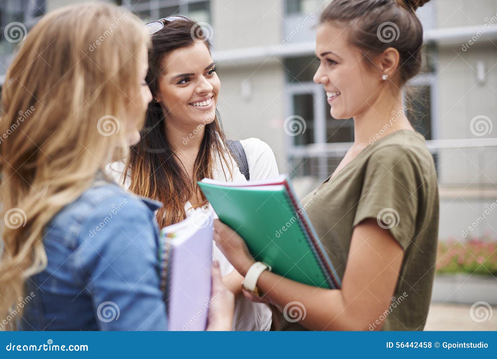 Busy students on campus stock photo. Image of holding - 56442458